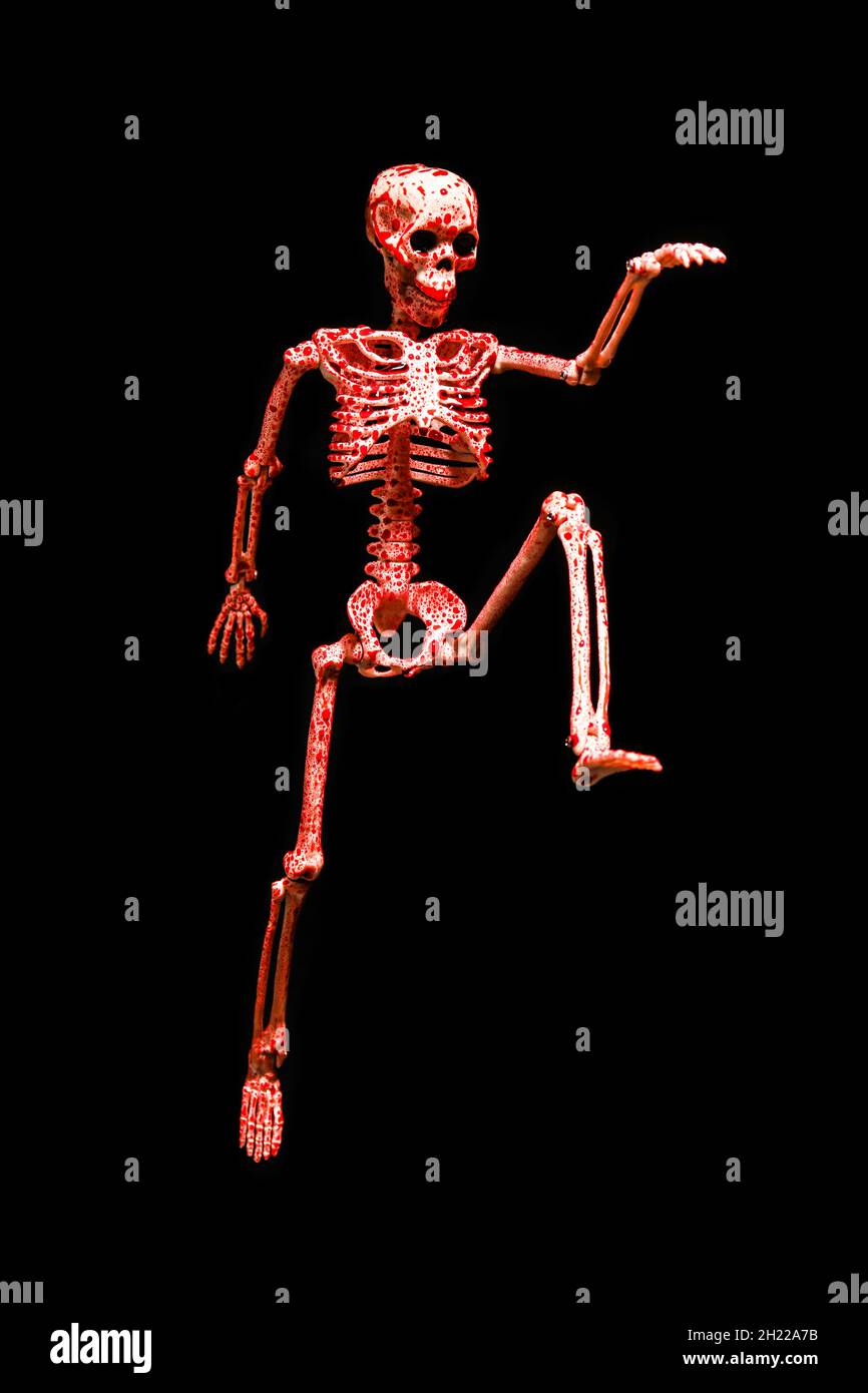 Bloodstained human skeleton on black background Stock Photo - Alamy