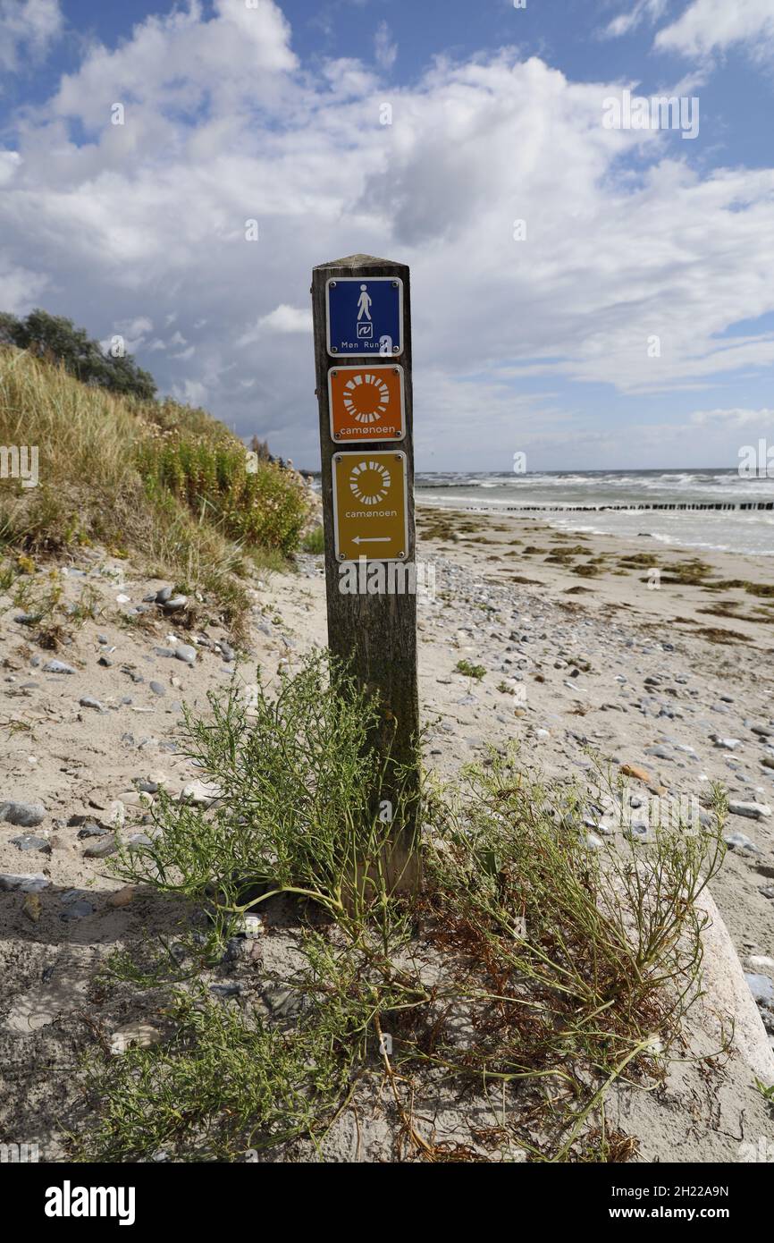 Vertical shot of trail signs on a pole at the beach outside Stock Photo ...