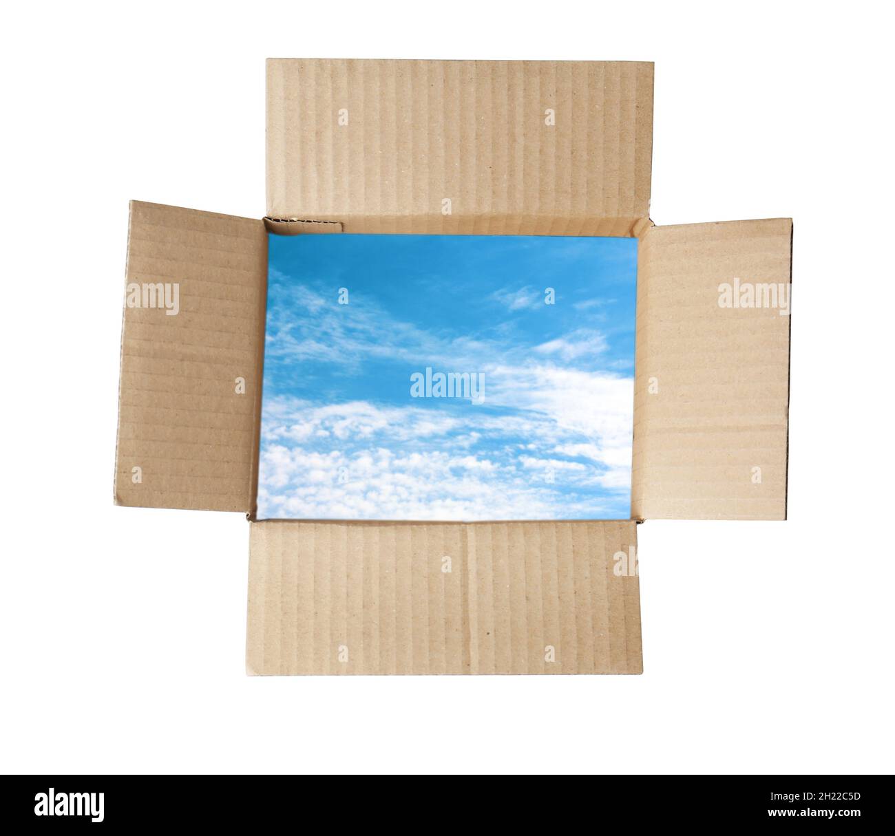 View of clear blue sky through open cardboard packaging on white ...