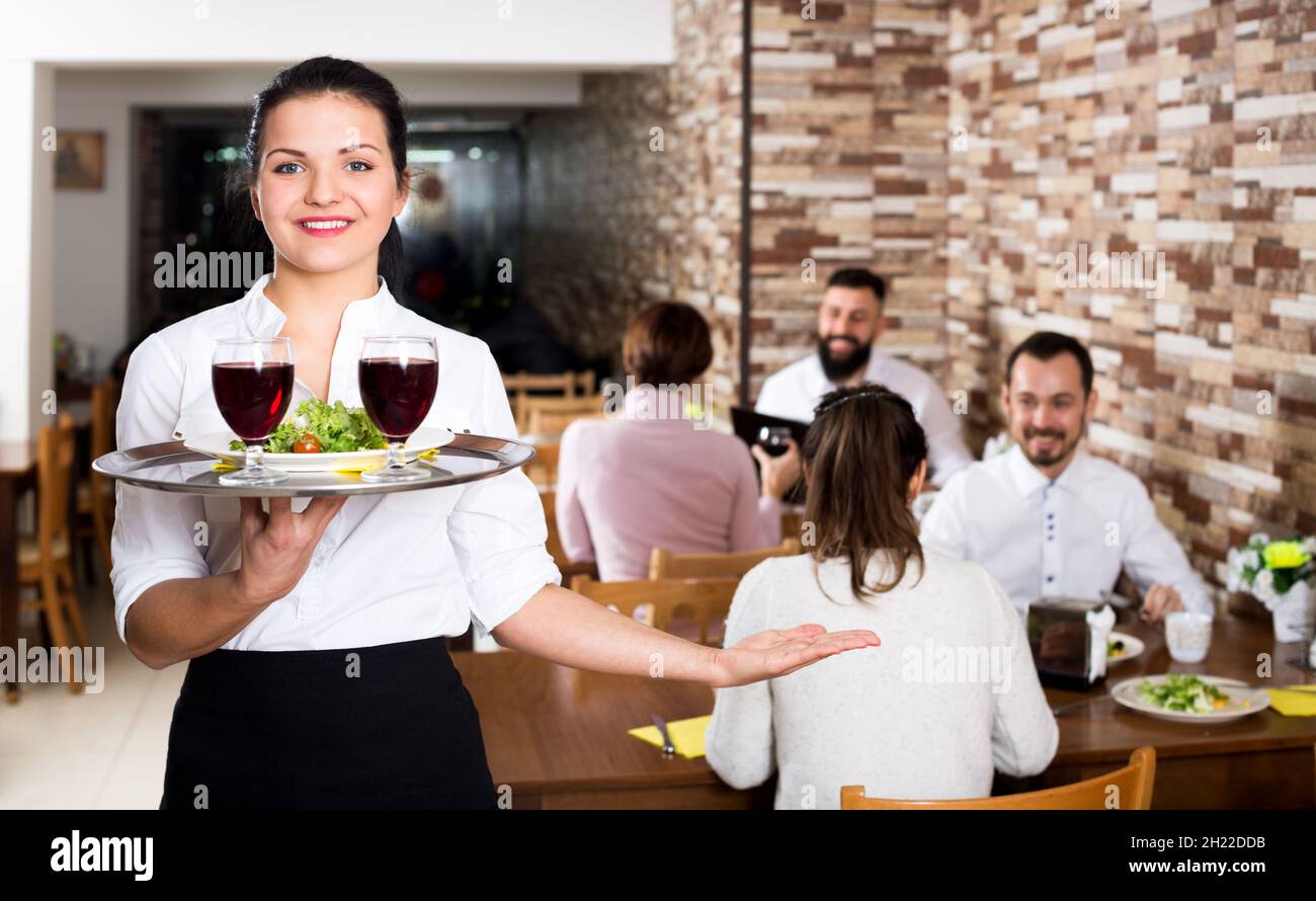 Female waiter showing country restaurant Stock Photo - Alamy