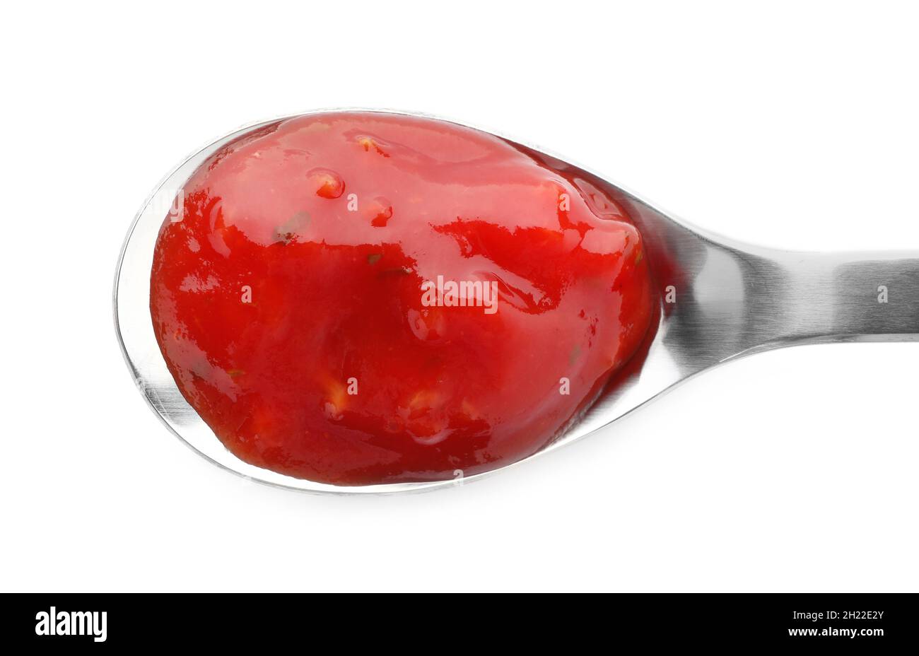 Spoon with spicy chili sauce on white background, top view Stock Photo ...