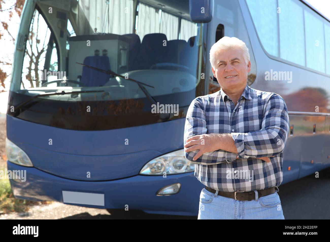 Professional driver standing near bus. Passenger transportation Stock ...