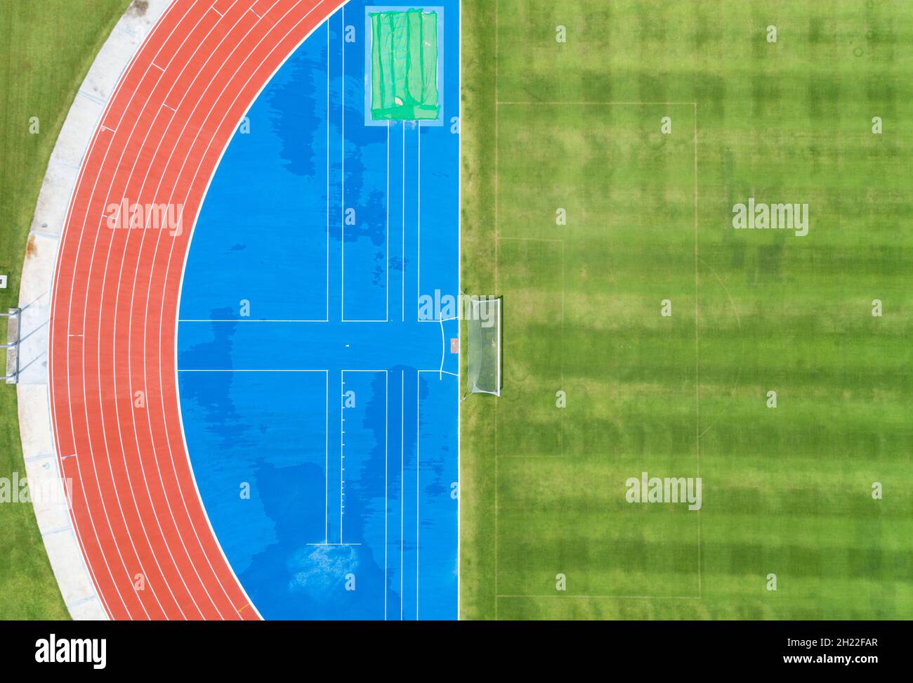 Aerial view of empty new soccer field from above with running tracks ...