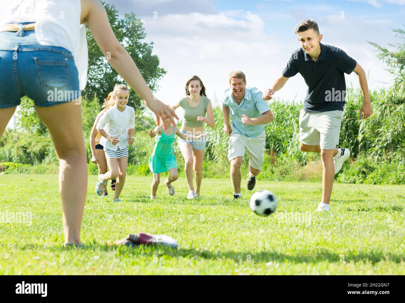 Woman playing with kids in meadow hi-res stock photography and images ...