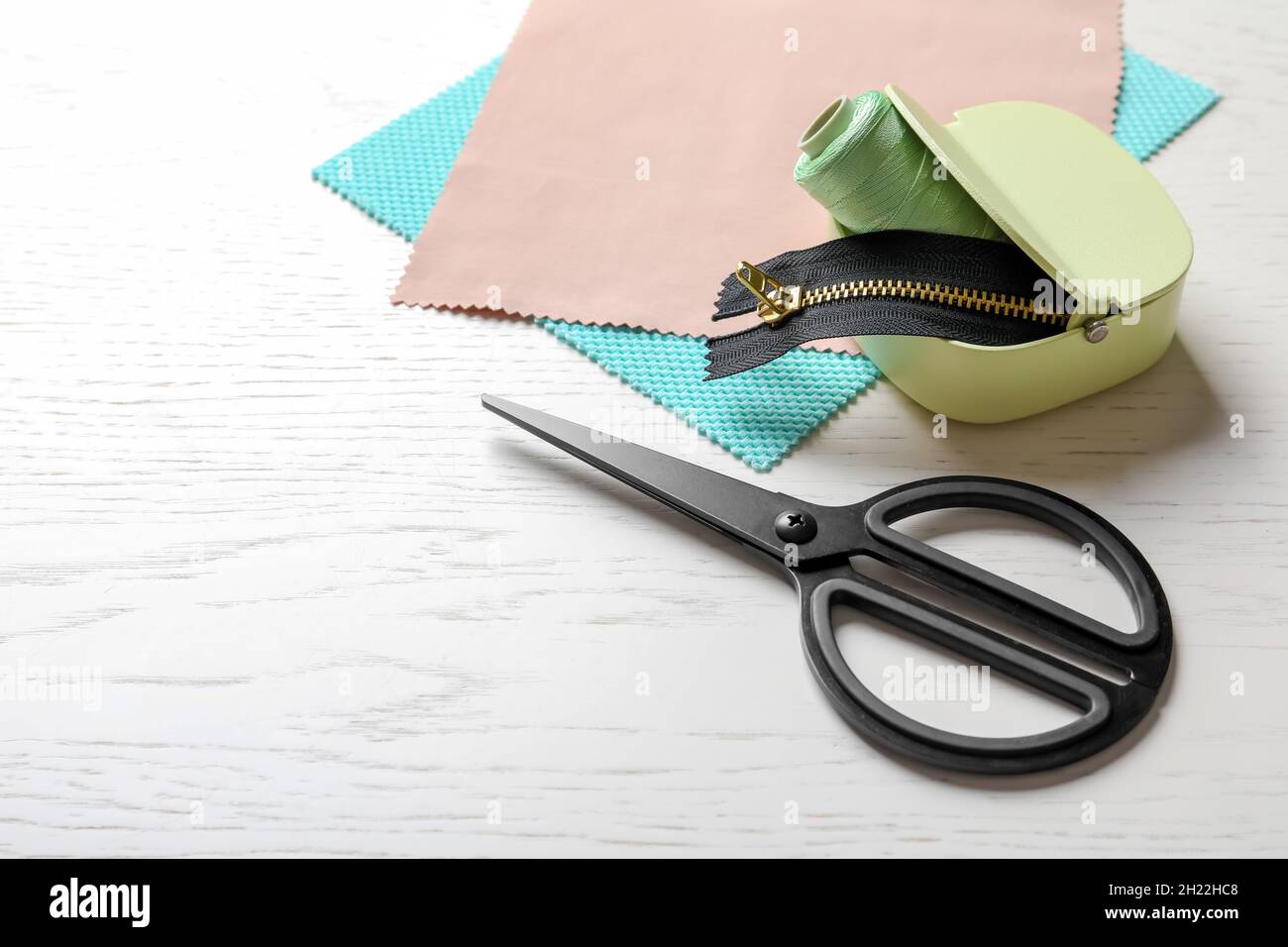 Set of tailoring accessories and fabric on light background Stock Photo ...