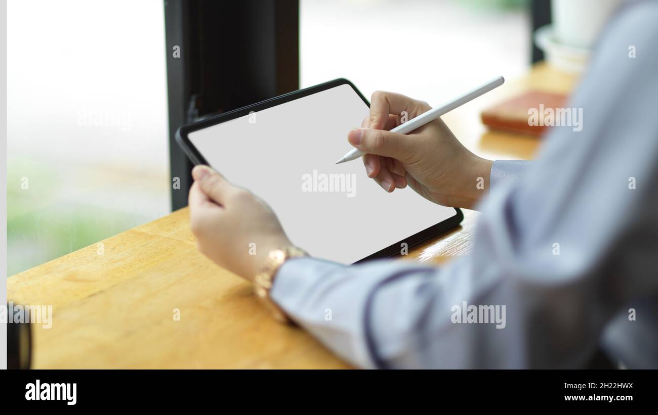 Successful businesswoman using stylus pen to create her presentation on ...