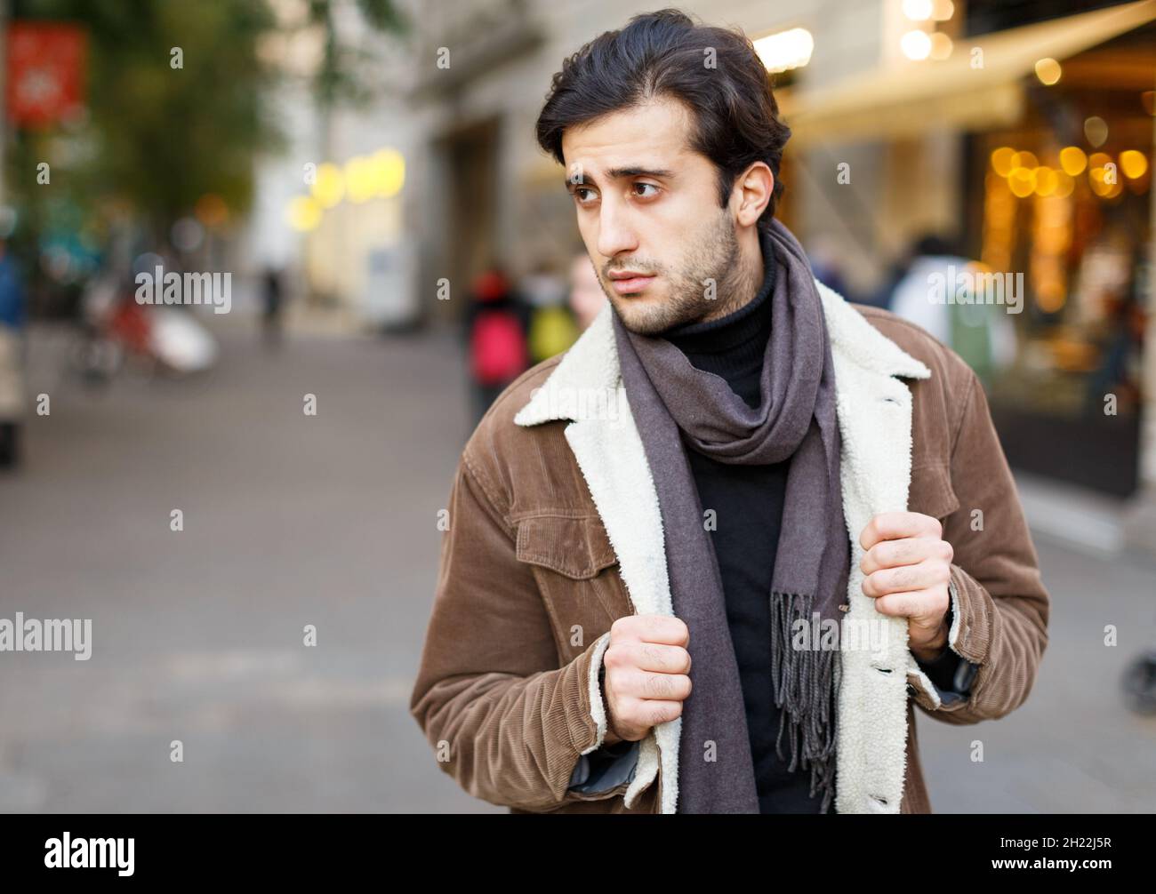 Adult man in winter coat standing in the historical city center Stock ...