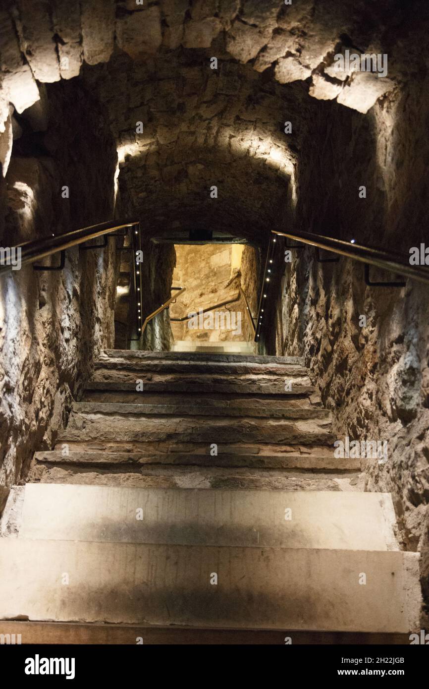 Vertical shot of a tunnel leading to a medieval underground dungeon ...