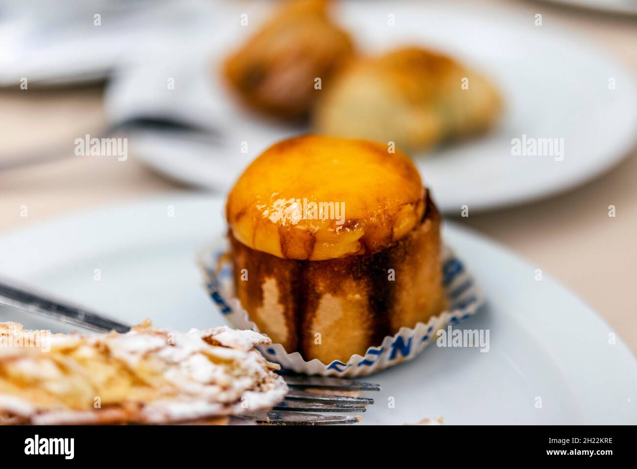 Small Spanish sweet pastry served with other delicious dessert on white ...