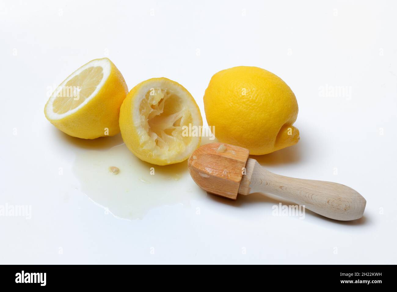 Lemons and lemon squeezer, squeezed lemon and lemon juice Stock Photo ...