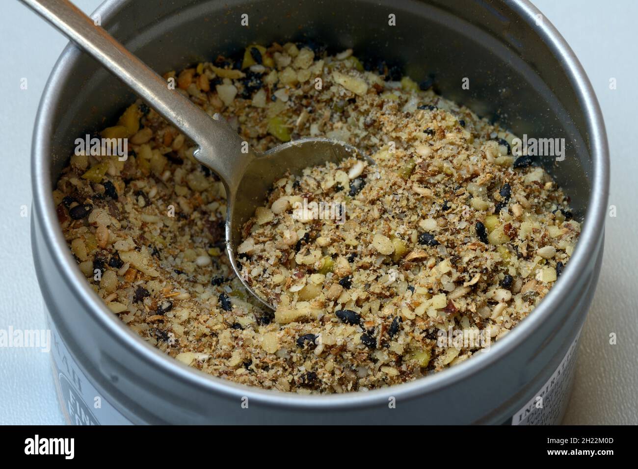 Dukkah, Arabic spice mix in a tin with a small spoon Stock Photo - Alamy