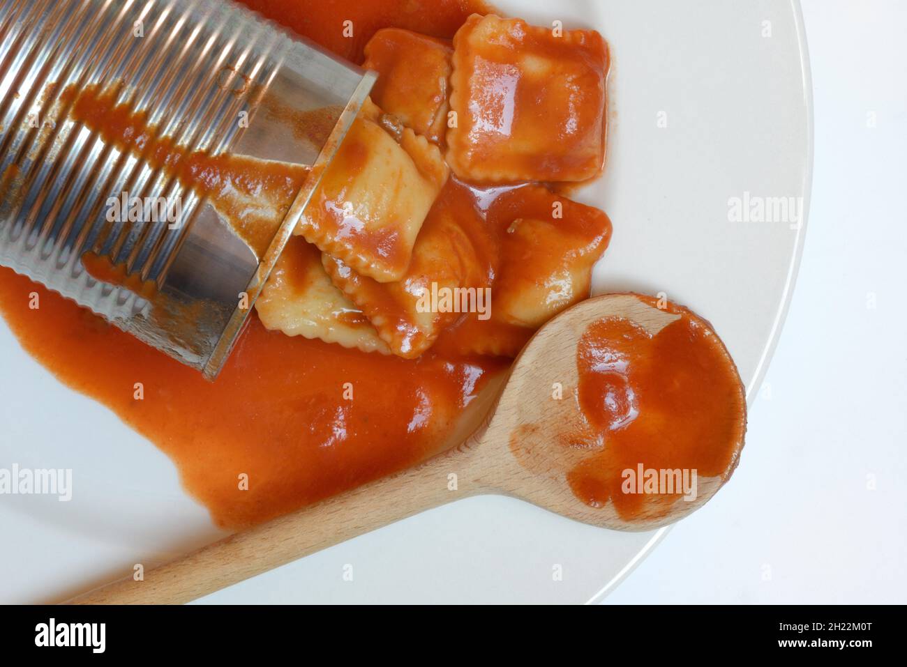 Opened tin can with ravioli and cooking spoon Stock Photo - Alamy