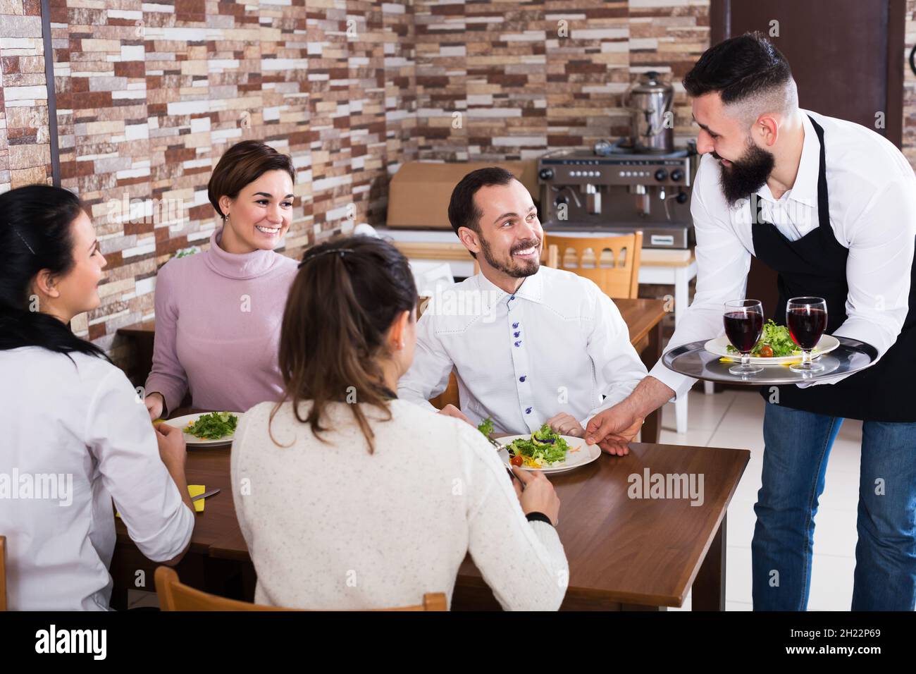 Waiter placing order in restaurant Stock Photo - Alamy