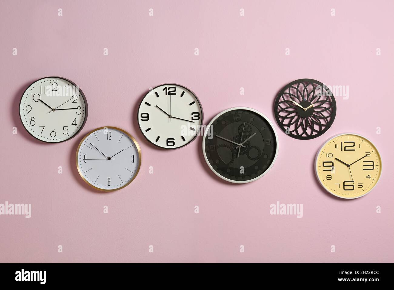 Different clocks on color background. Time management Stock Photo - Alamy
