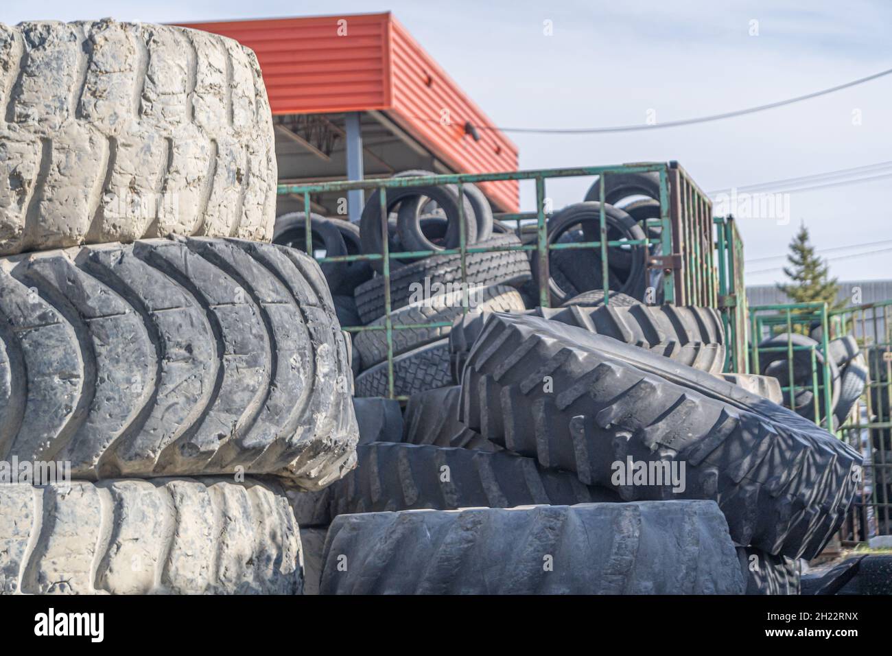 Old tires stacked up together at a car workshop garage Stock Photo - Alamy