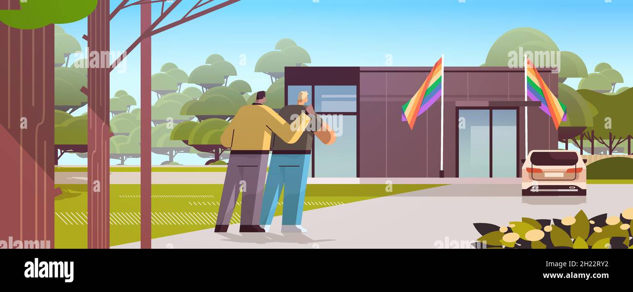 gay couple hugging and looking at new modular house with rainbow flags ...
