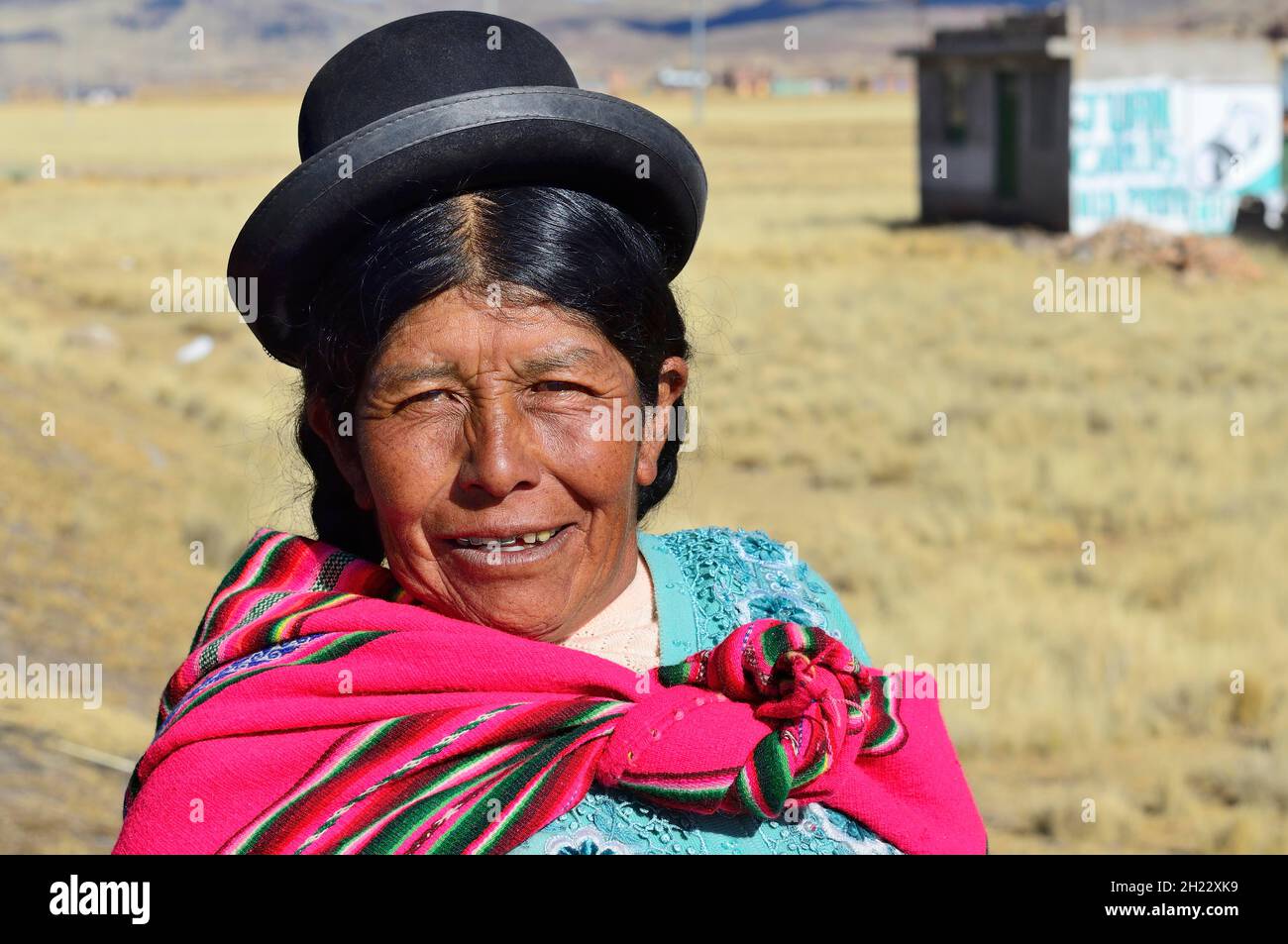 Older indigenous woman with hat smiling at the camera, Lake Titicaca ...