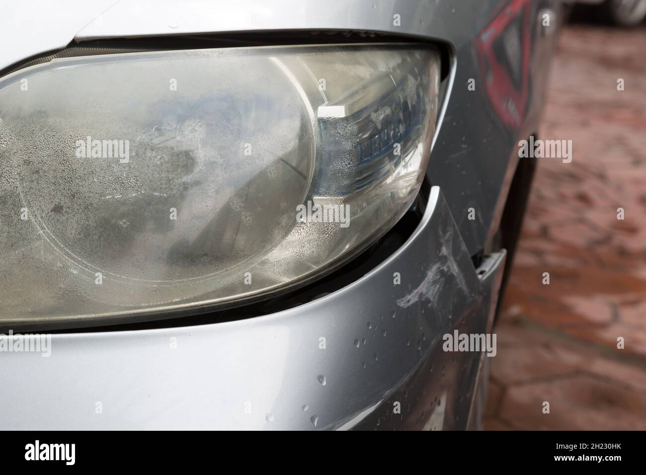 Closeup of crashed car hit on the front bumper off , accident happen on ...