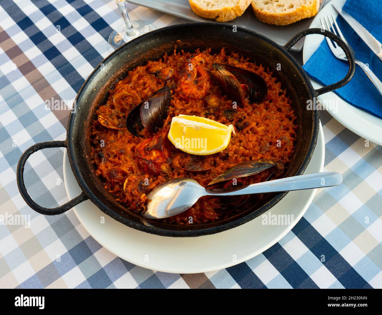 Traditional Valencian seafood paella with shrimps, squid and clams ...