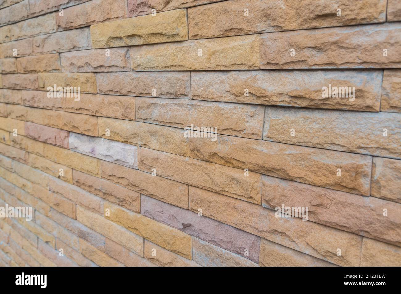 yellow stone wall made with stone blocks use for background Stock Photo ...