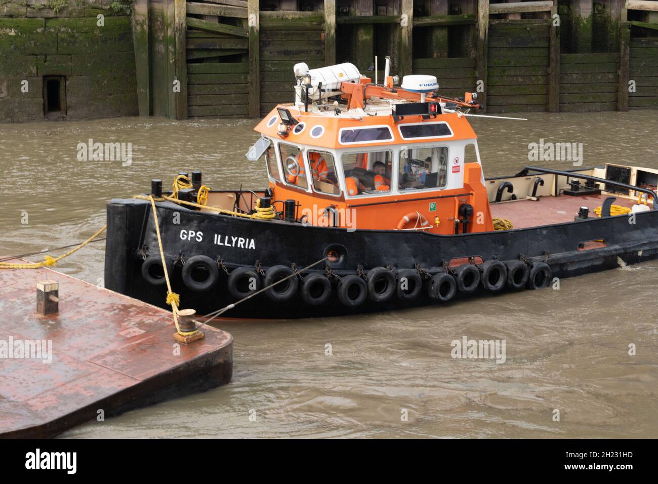 GPS ILLYRIA pushing a marine barge along Deptford Creek, Greenwich ...