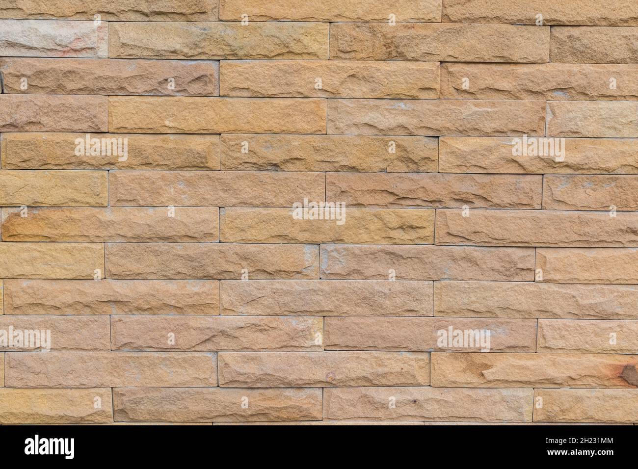 yellow stone wall made with stone blocks use for background Stock Photo ...