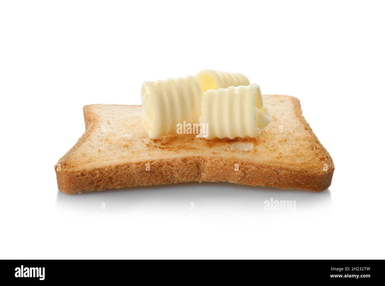 Toast with tasty butter curls on white background Stock Photo - Alamy
