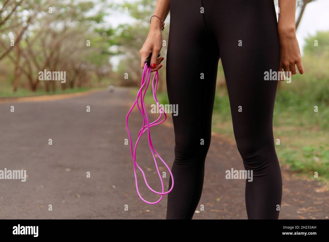 close up woman jumping pink rope. bali Stock Photo - Alamy