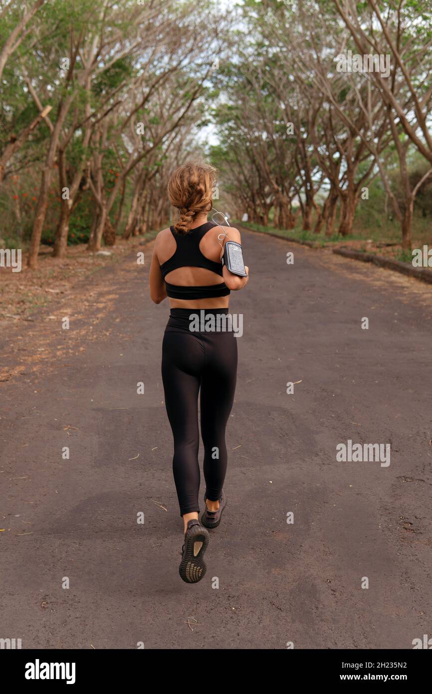 beautiful girl go in for sports. autumn. bali Stock Photo - Alamy