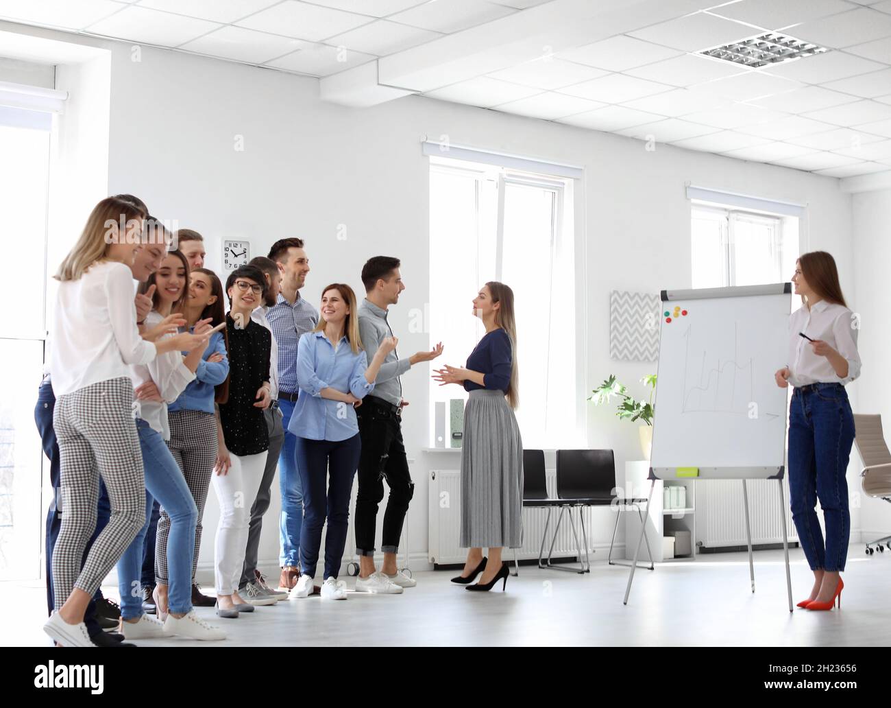 Female business trainer giving lecture in office Stock Photo - Alamy