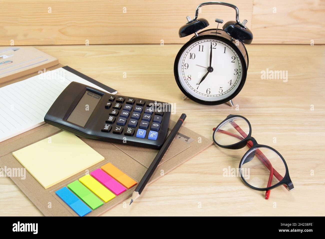 pencil, folder file, Calculator, glasses clock on wood table concept ...