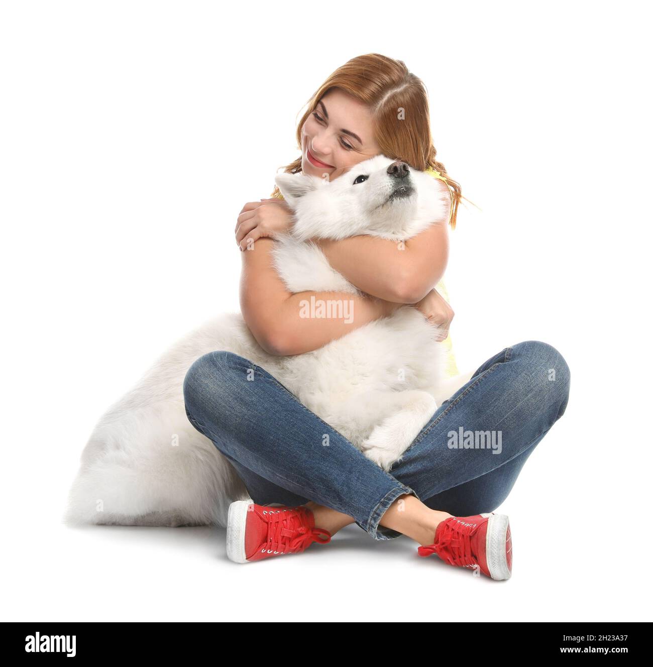Beautiful woman hugging her dog on white background Stock Photo - Alamy