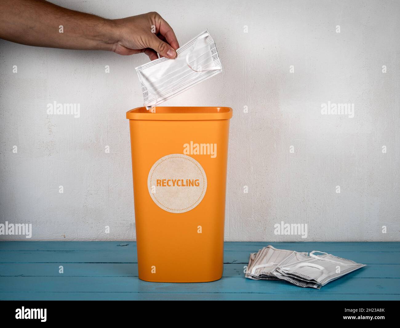 Throw the face mask into a waste container. Waste sorting and recycling ...