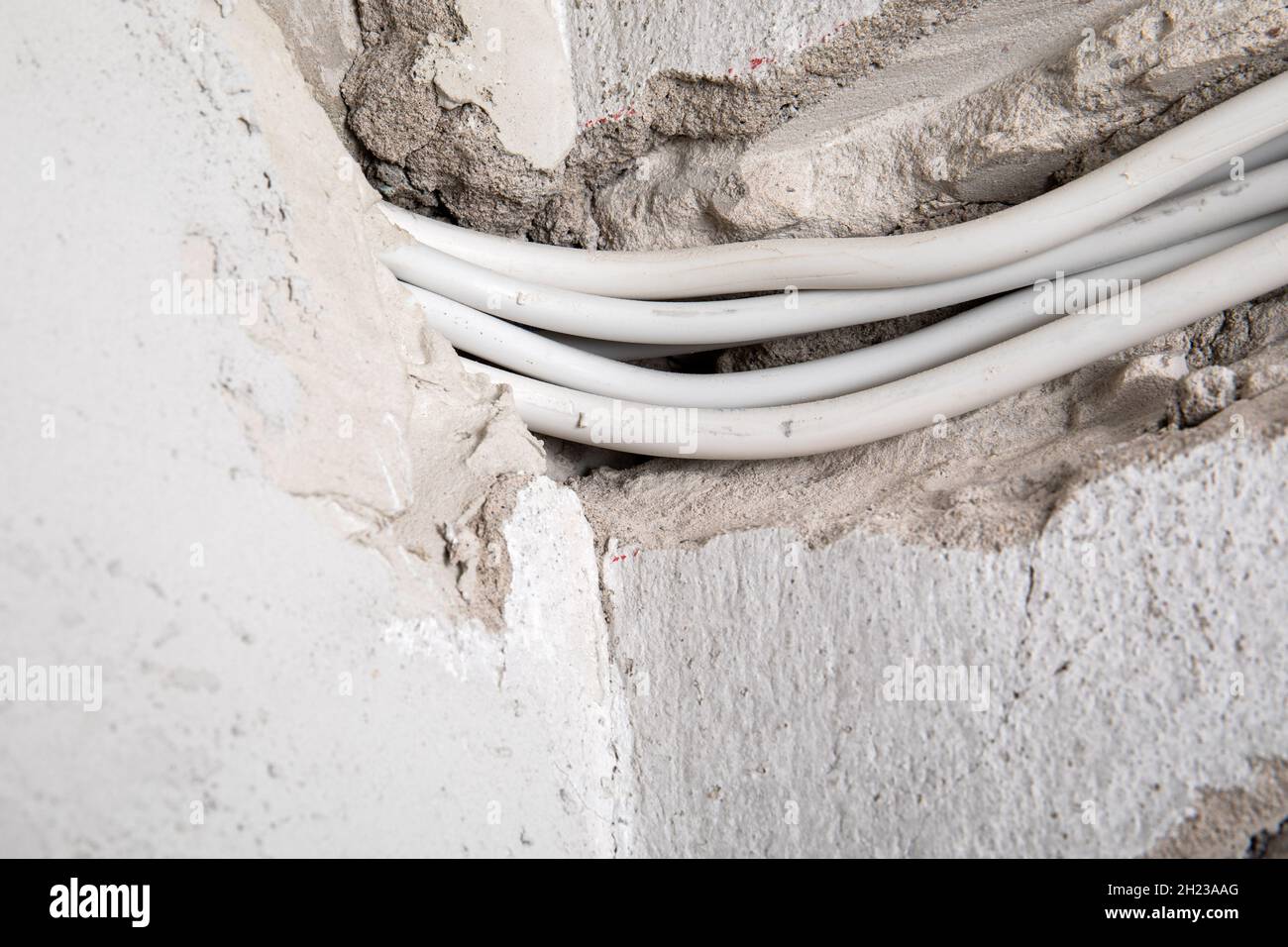 Electrical wires built into the wall. Plaster and construction site ...