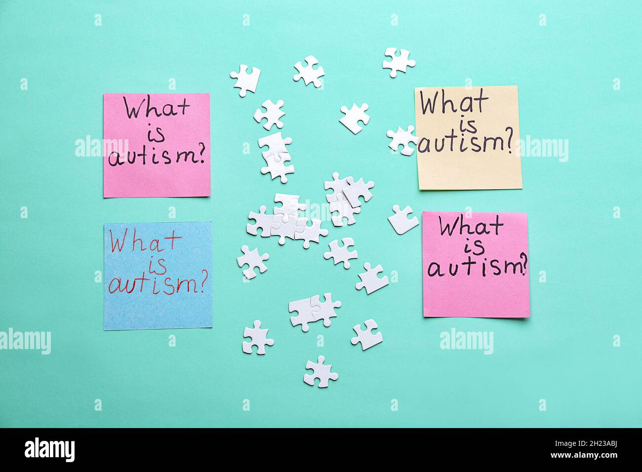 Sticky notes with phrase "What is autism?" and puzzle pieces on color ...