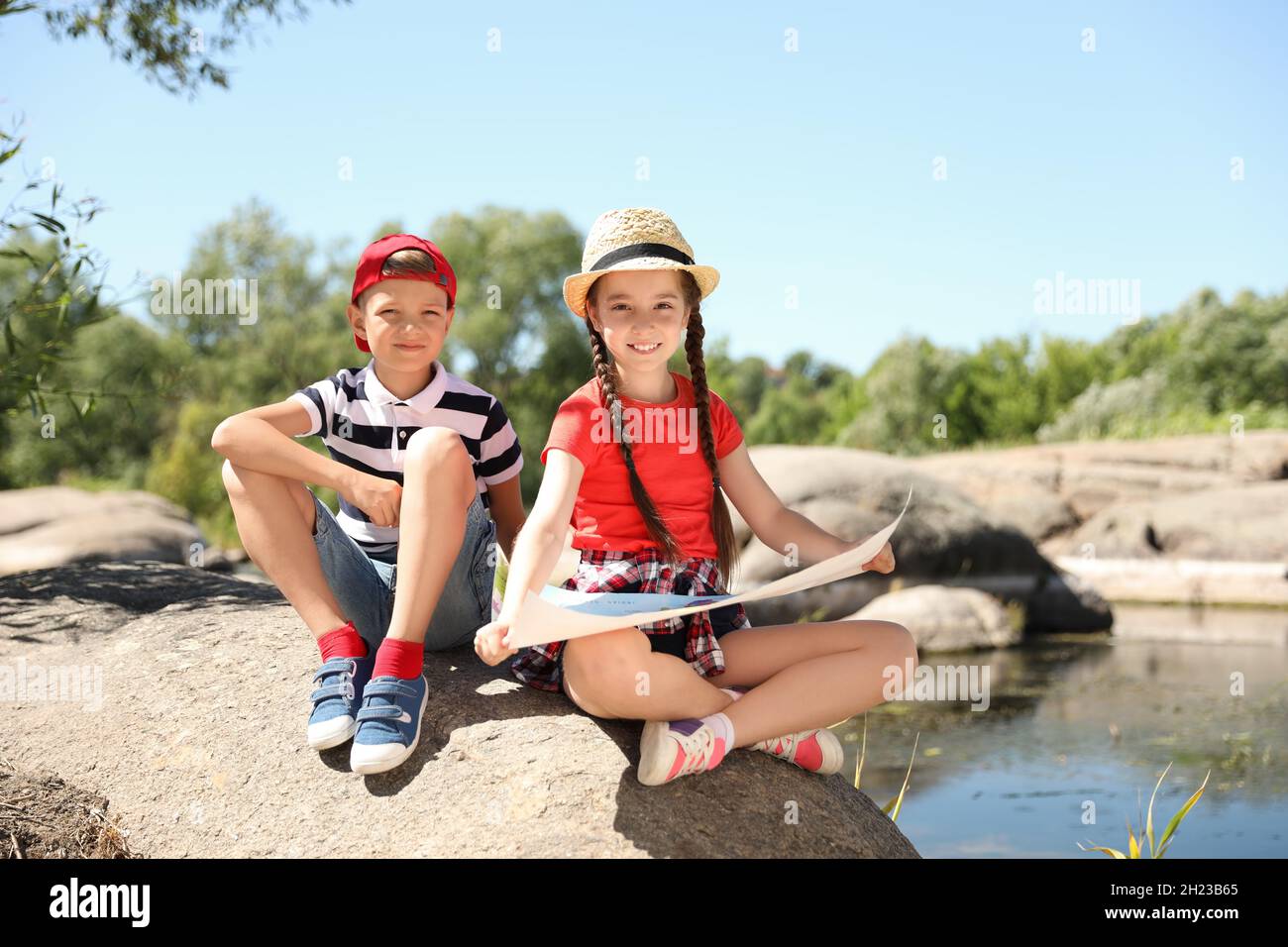 Little children with map outdoors. Summer camp Stock Photo - Alamy