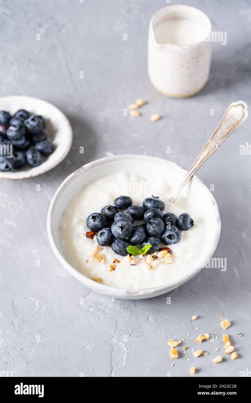 Rice porridge on coconut milk with blueberries. Healthy breakfast ...