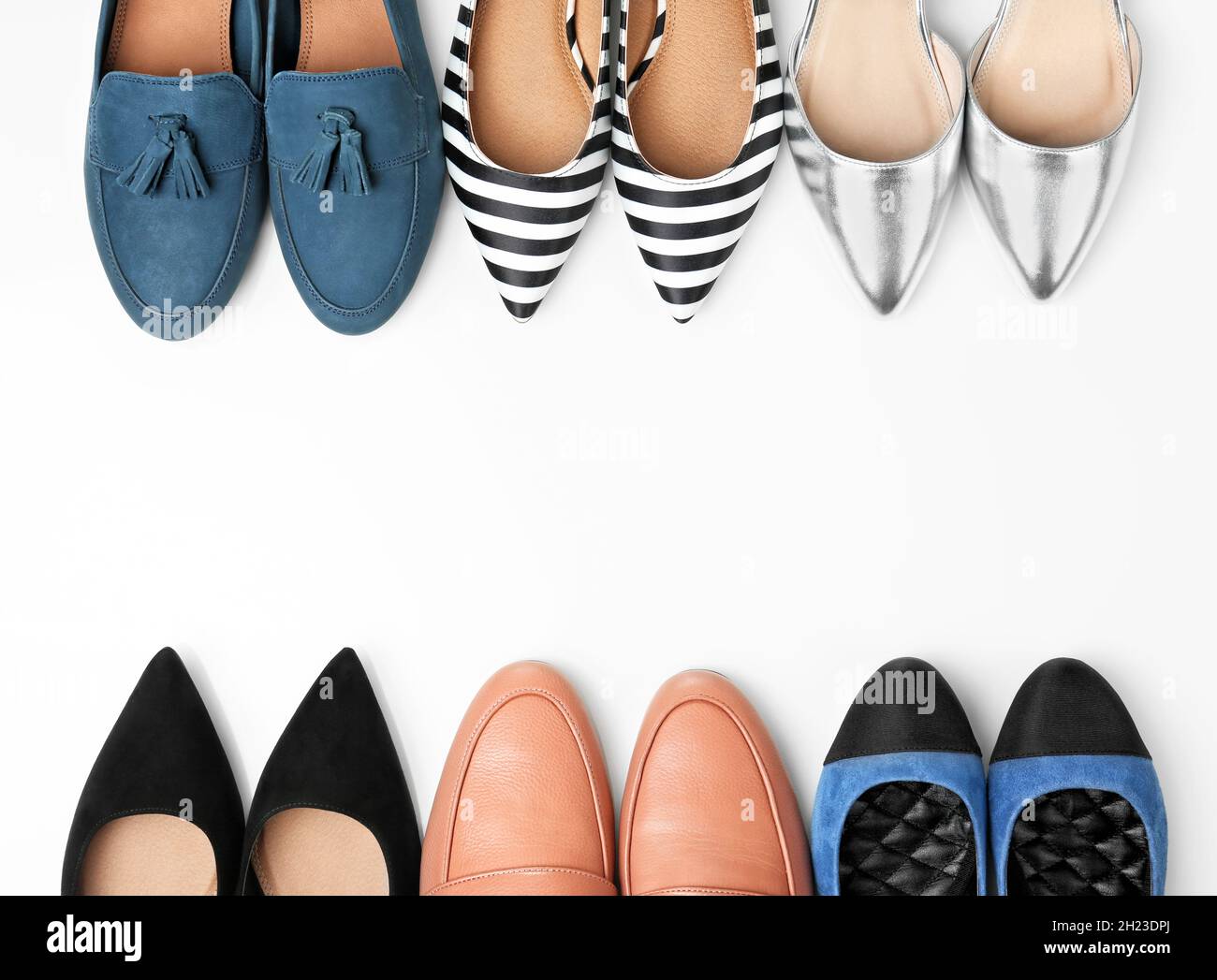 Different female shoes on white background, top view Stock Photo - Alamy
