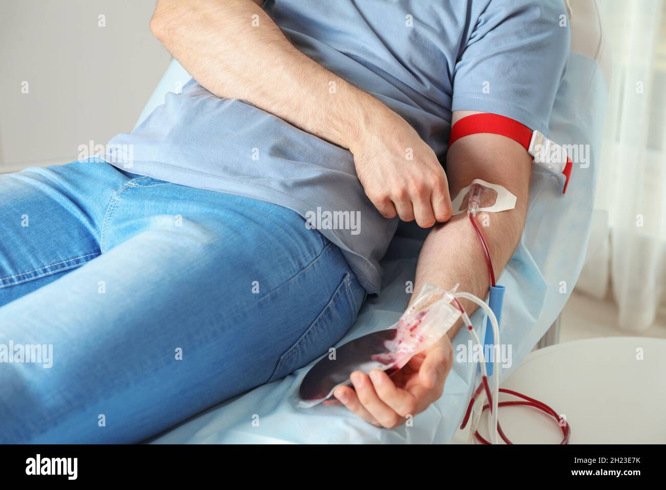 Man donating blood to save someone's life in hospital Stock Photo - Alamy