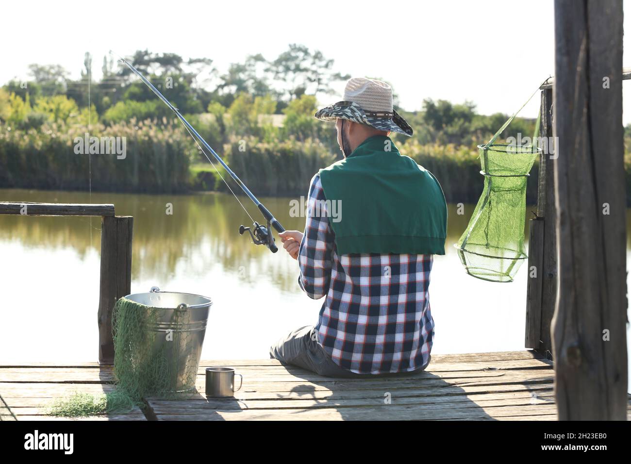 Man sitting on bucket fishing hi-res stock photography and images - Alamy