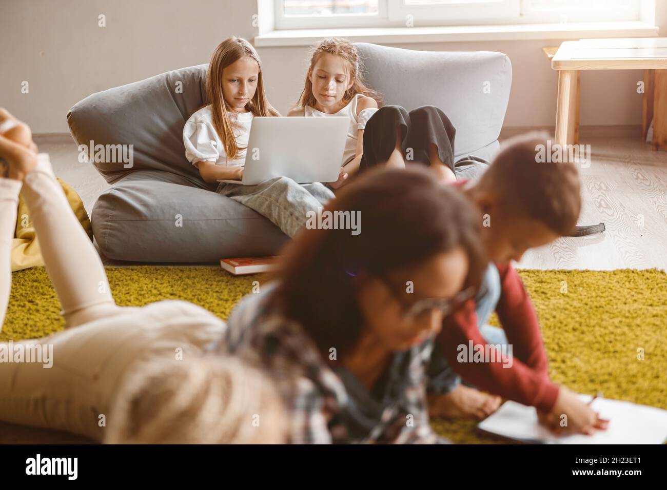 Children using laptop while sitting in classroom Stock Photo - Alamy