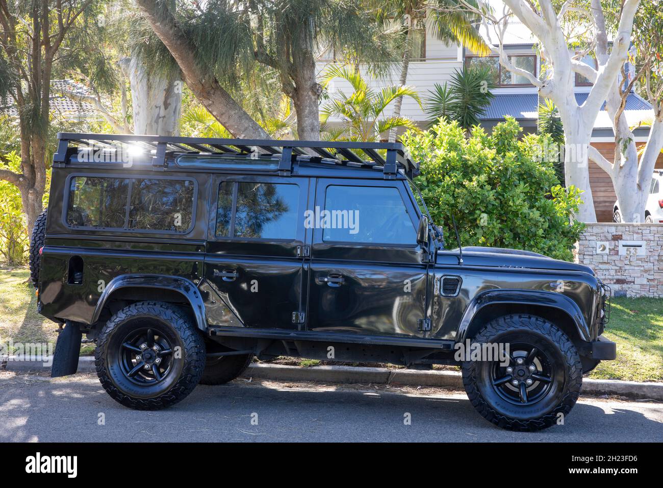 Black Land Rover defender 110 model parked in a Sydney street on a ...