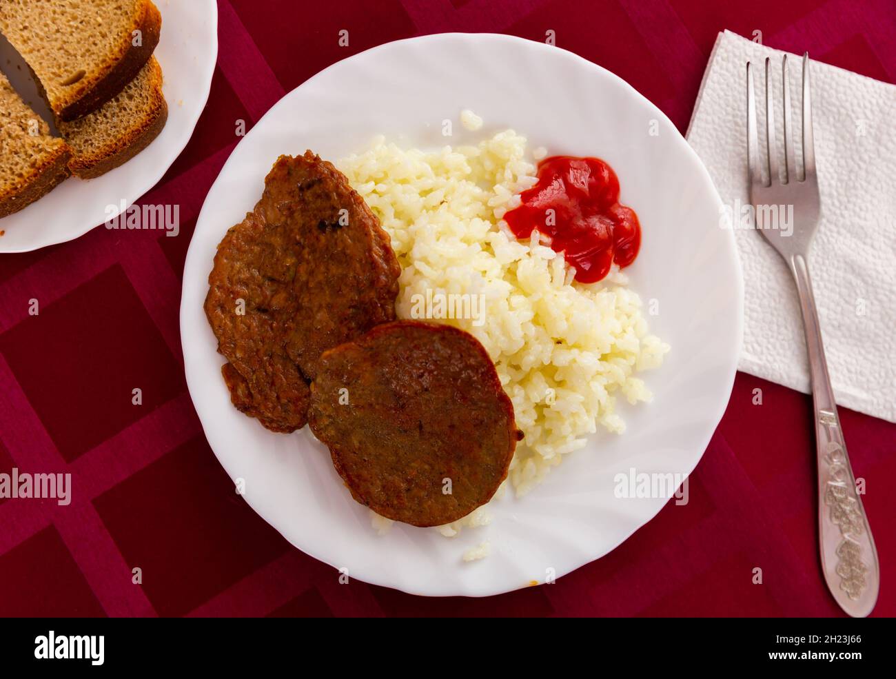 Traditional dish of Russian cuisine is cutlets with rice Stock Photo ...