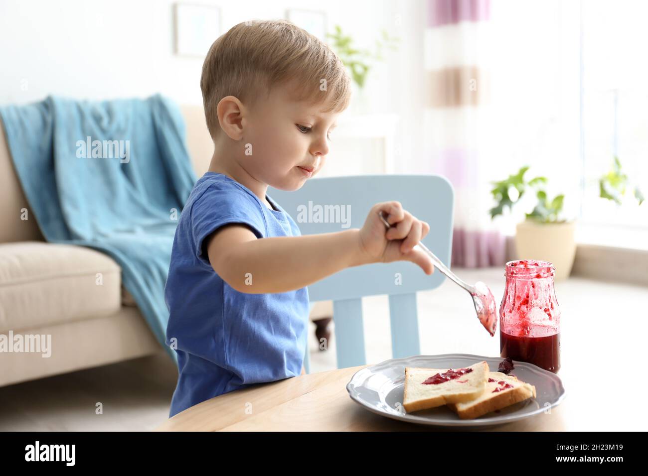 Kid eating jam on toast hi-res stock photography and images - Alamy