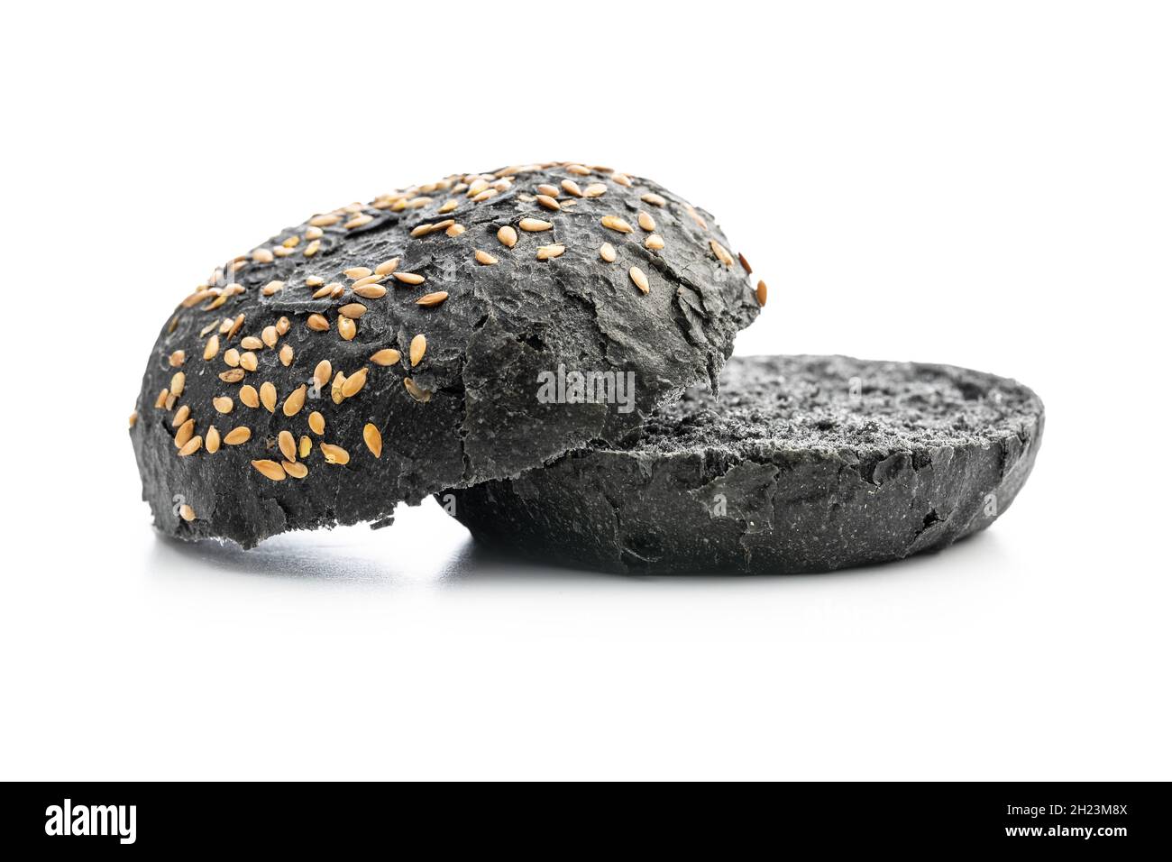 Black bun. Dark pastry with sesame seeds isolated on white background ...