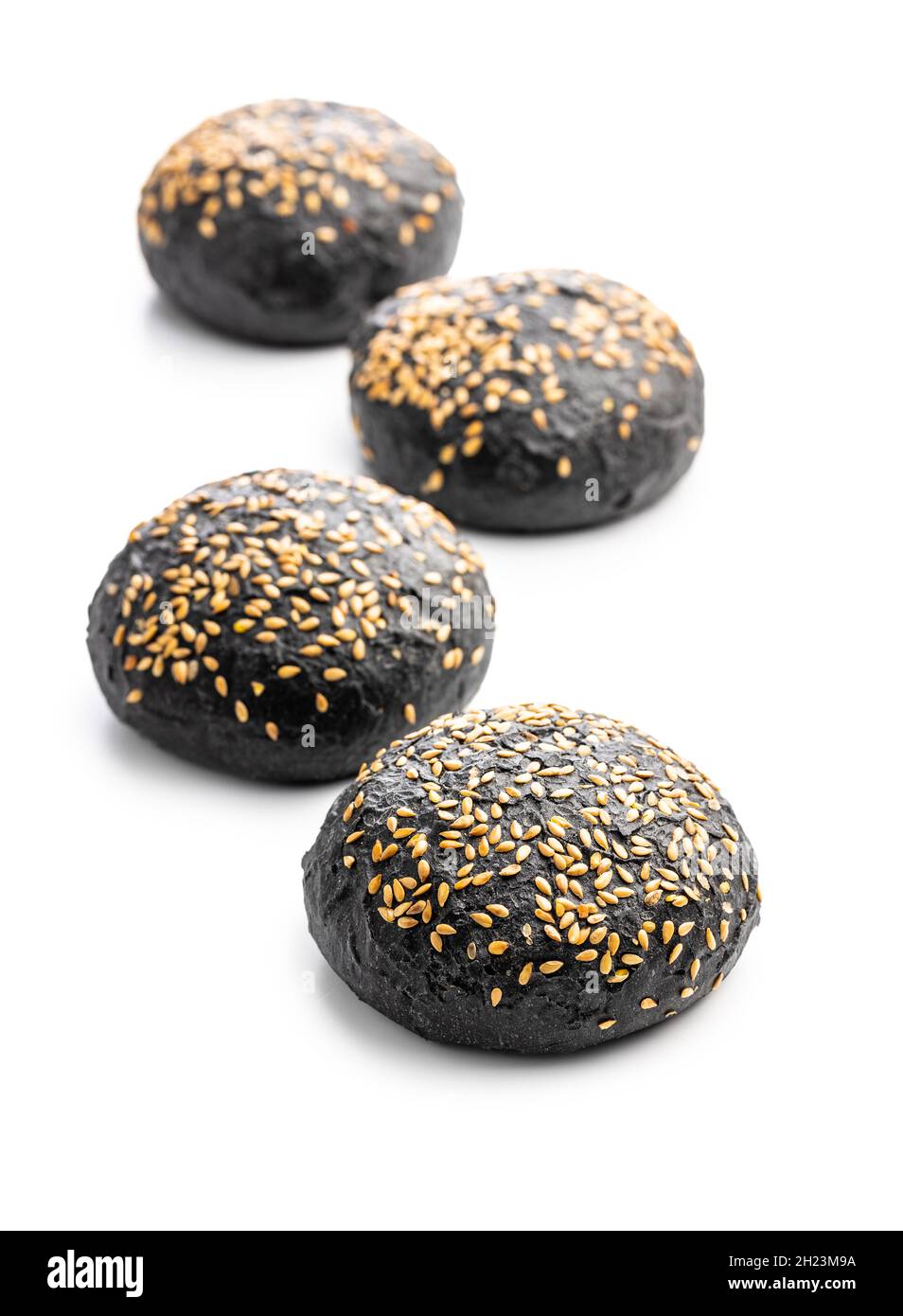 Black bun. Dark pastry with sesame seeds isolated on white background ...