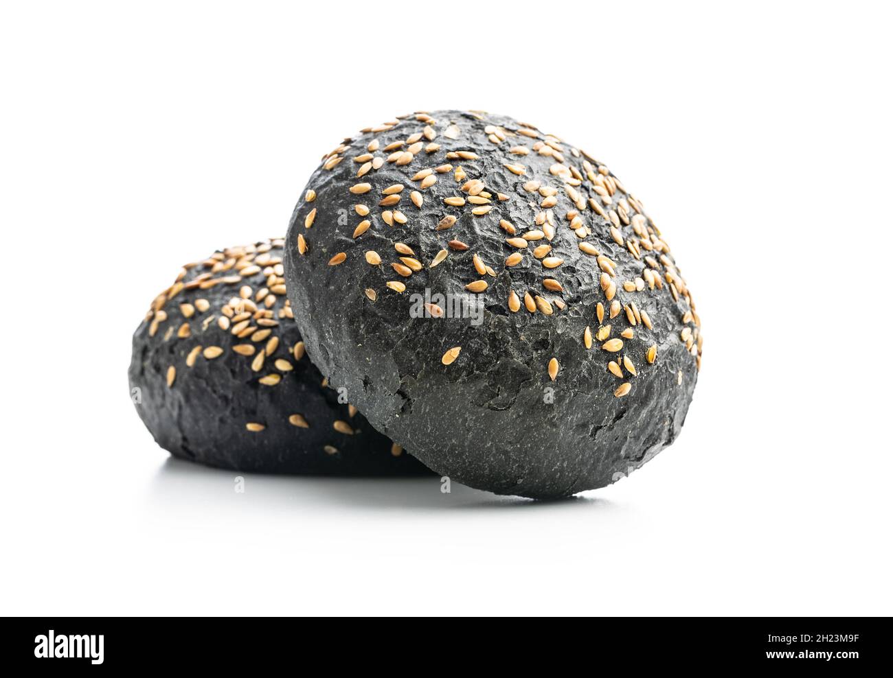 Black bun. Dark pastry with sesame seeds isolated on white background ...