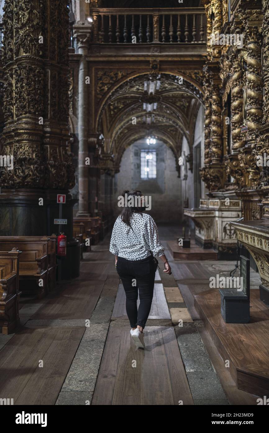 Beautiful vertical shot of a girl walking in the corridors of a modern ...