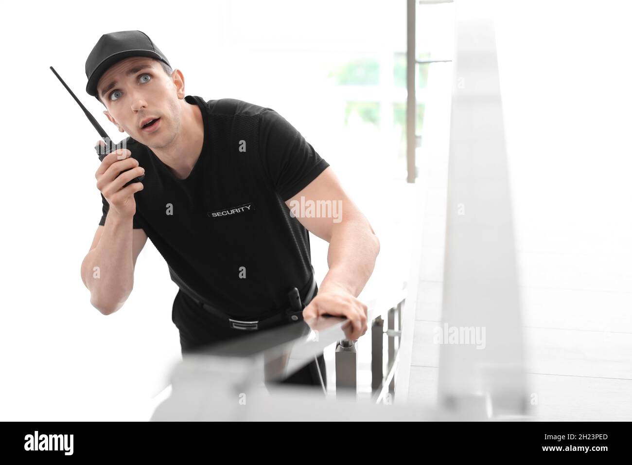 Male security guard with portable radio transmitter indoors Stock Photo ...
