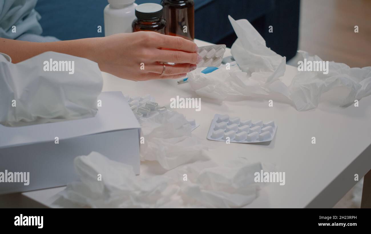 Close up of hand holding tablets with capsules and pills against cold ...